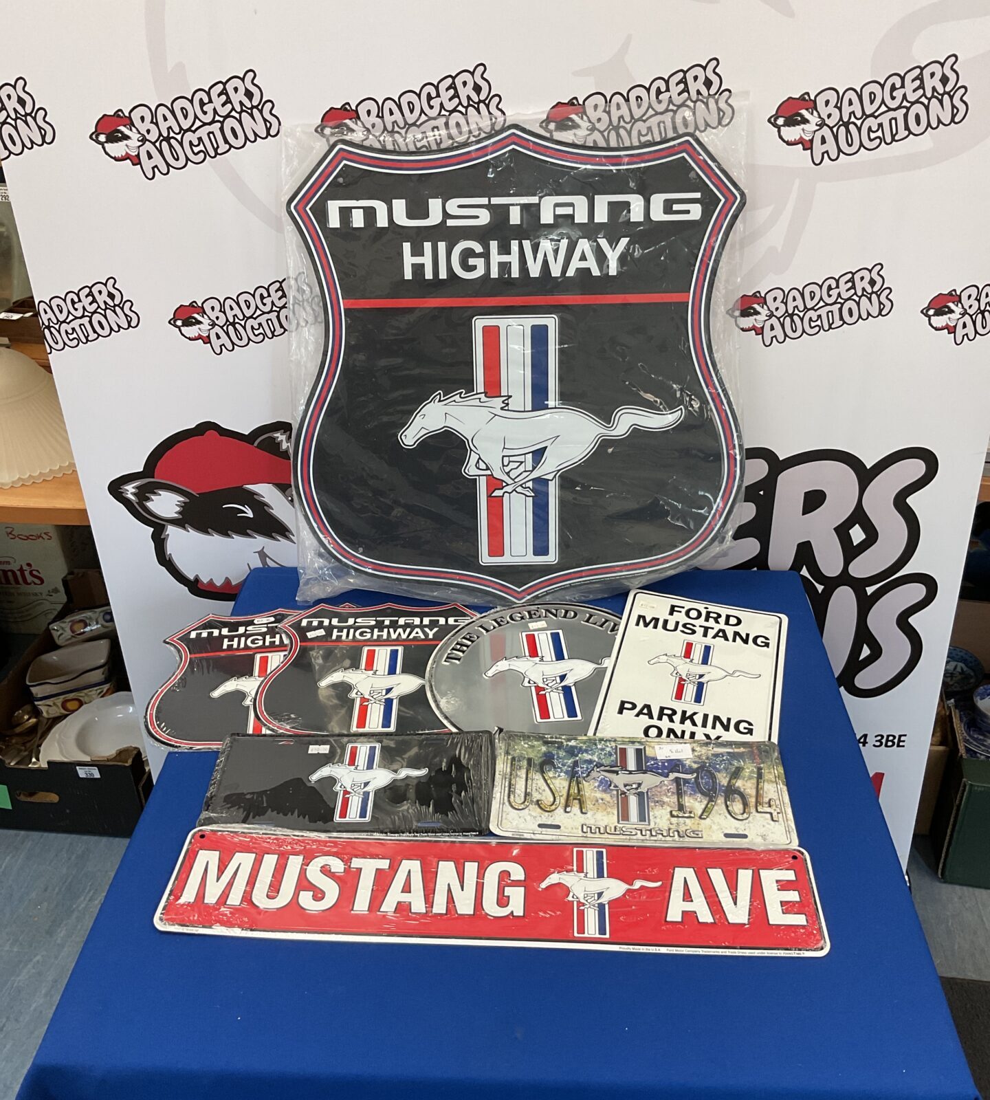 Lot if 8 new tin mustang signs – Badgers Auctions