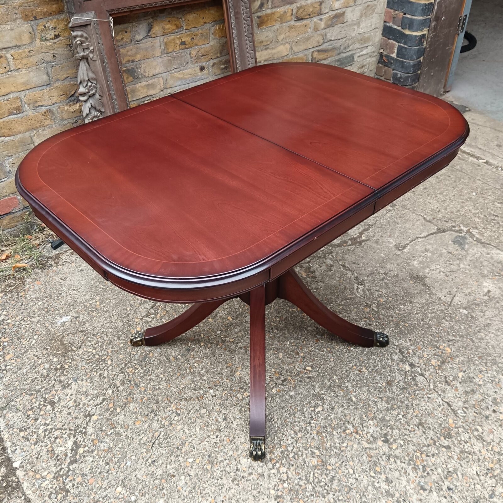 Reproduction rectangular dark wood table with curved corners, central ...