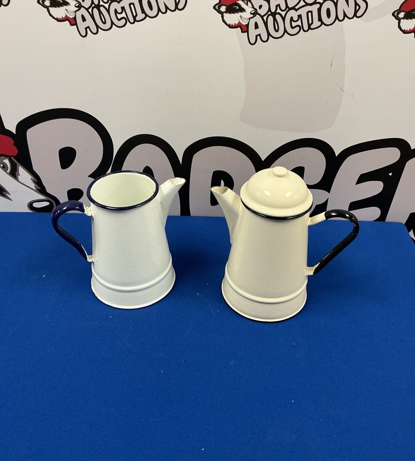 Two enamelled Jugs – Badgers Auctions