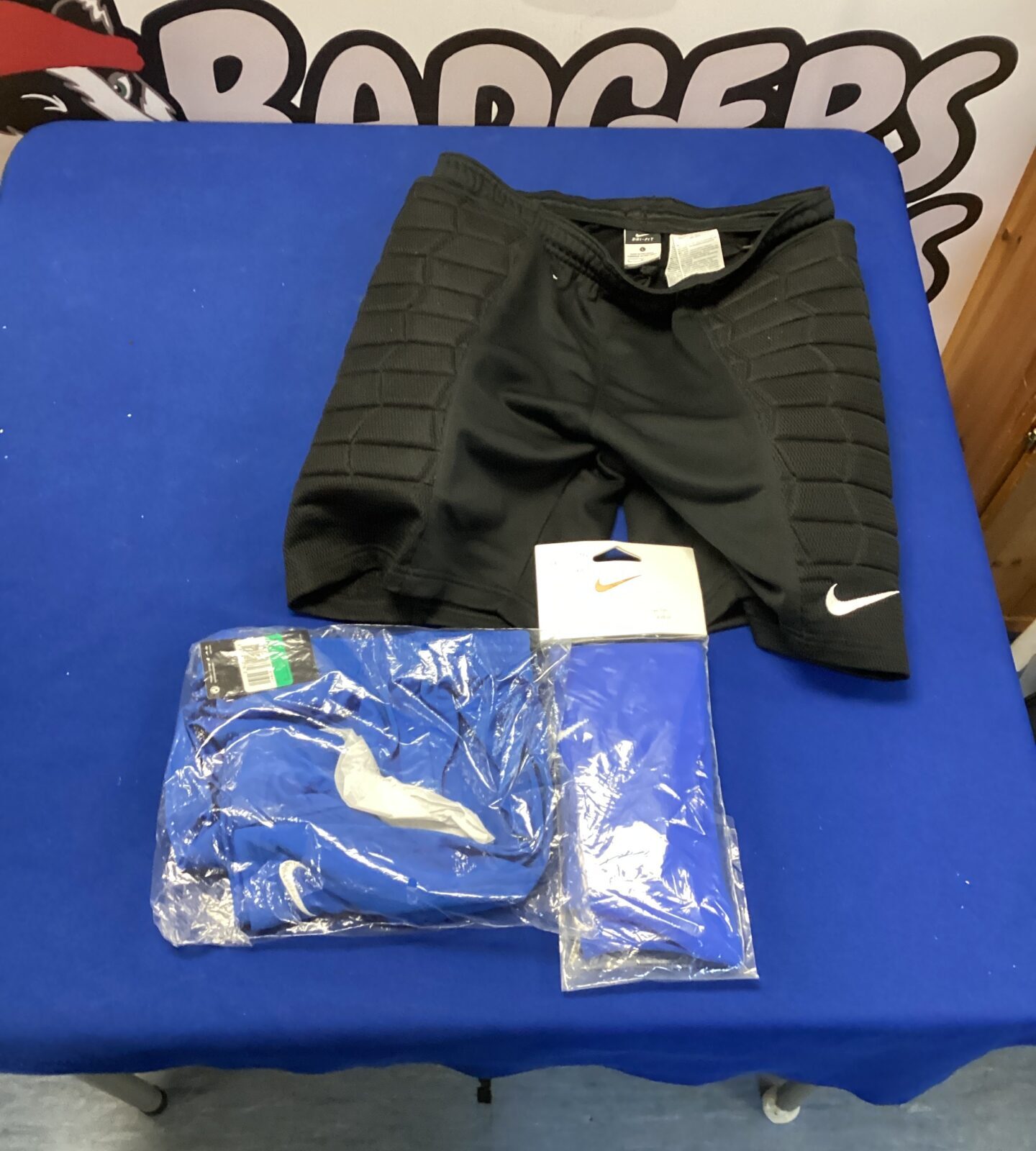 Three Nike football pieces of clothing, including goalie shots ...