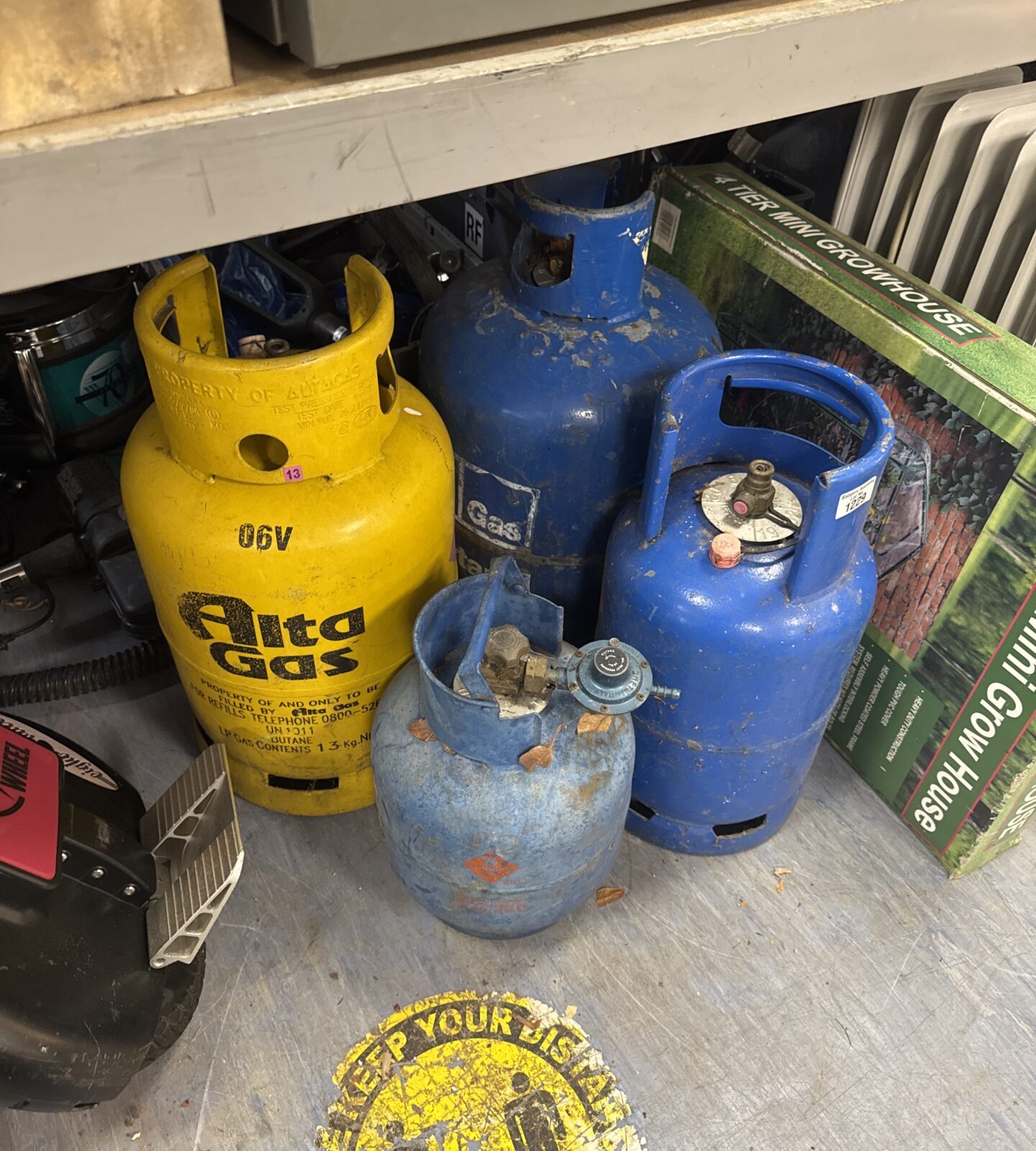 Four assorted patio gas canisters – two feel empty, two partial ...