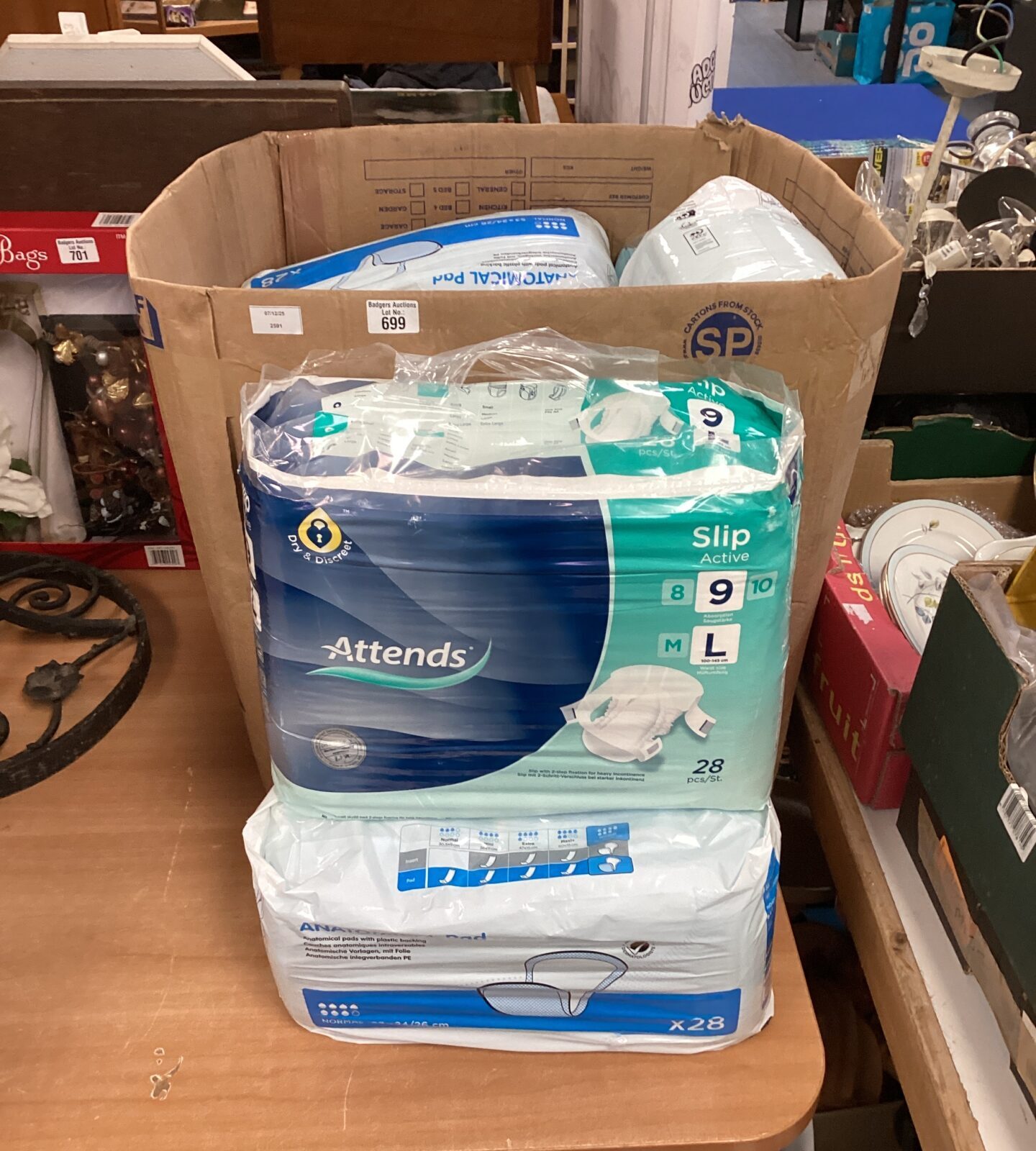 Box of seven packs of adult incontinence pants – Badgers Auctions