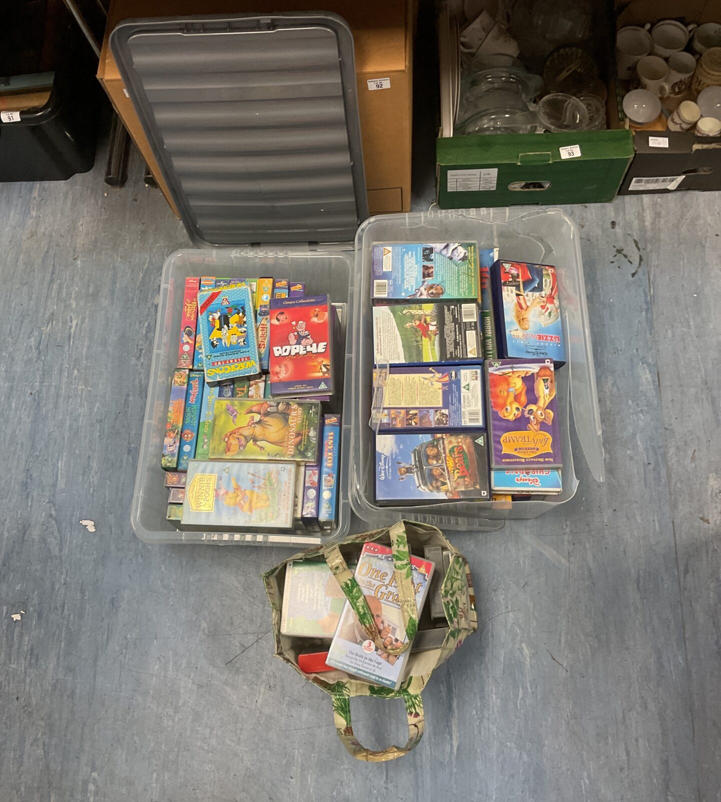 Two boxes and a bag of VHS movies – Badgers Auctions